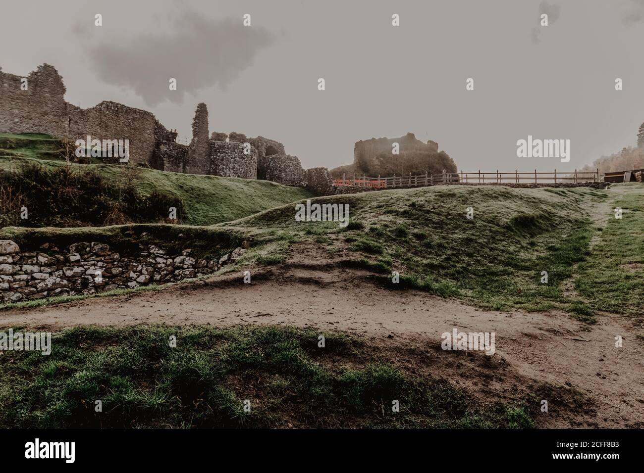 Destroyed old stone castle with fog with walls and stairs with tower on ...