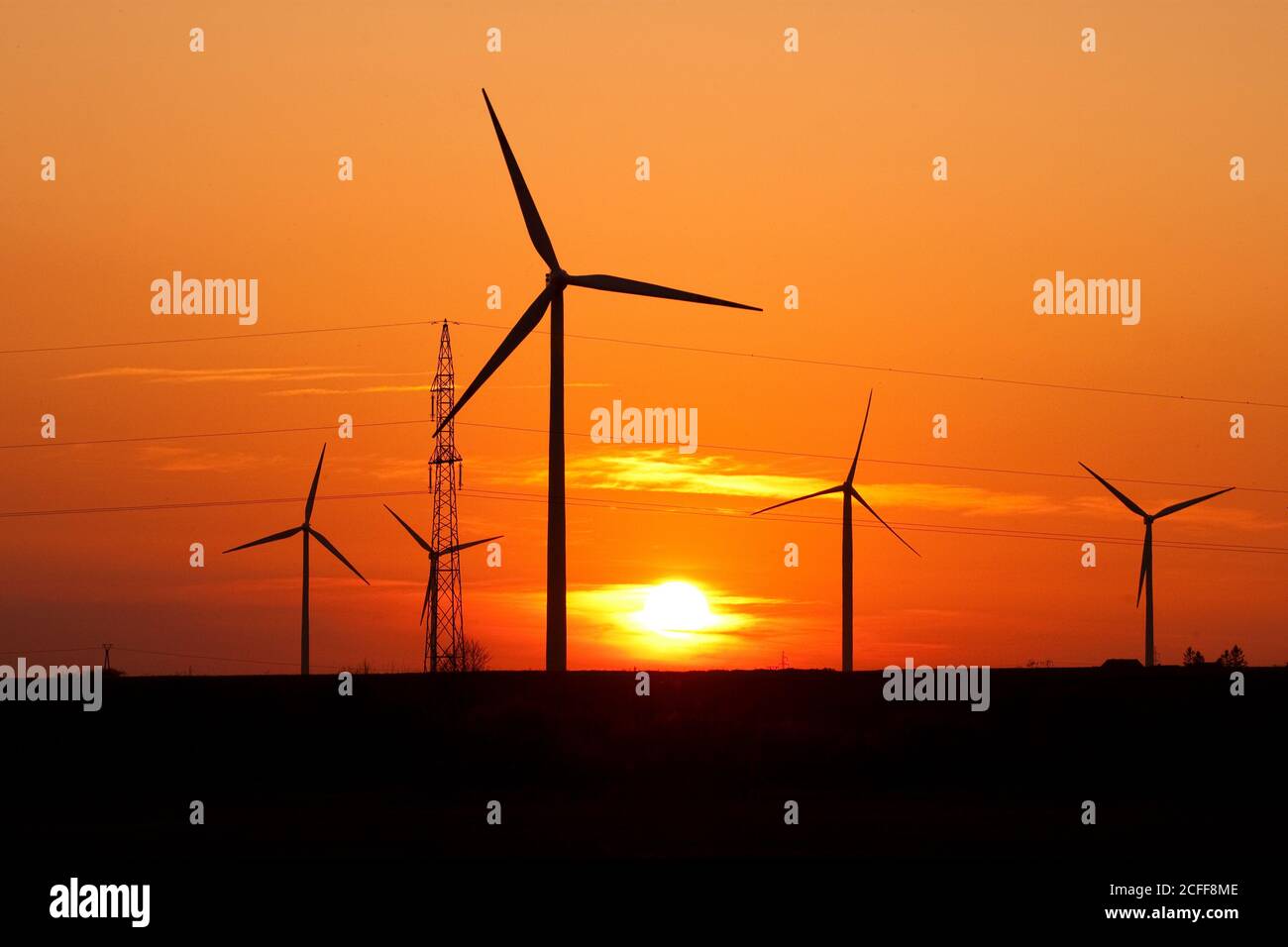 Wind turbine farm over sunset Stock Photo - Alamy