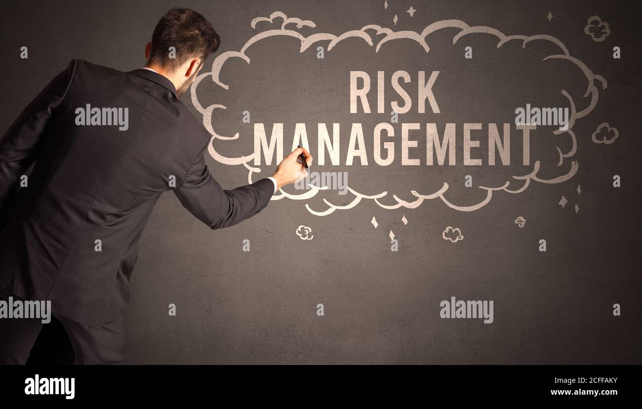 businessman drawing a cloud with RISK MANAGEMENT inscription inside ...