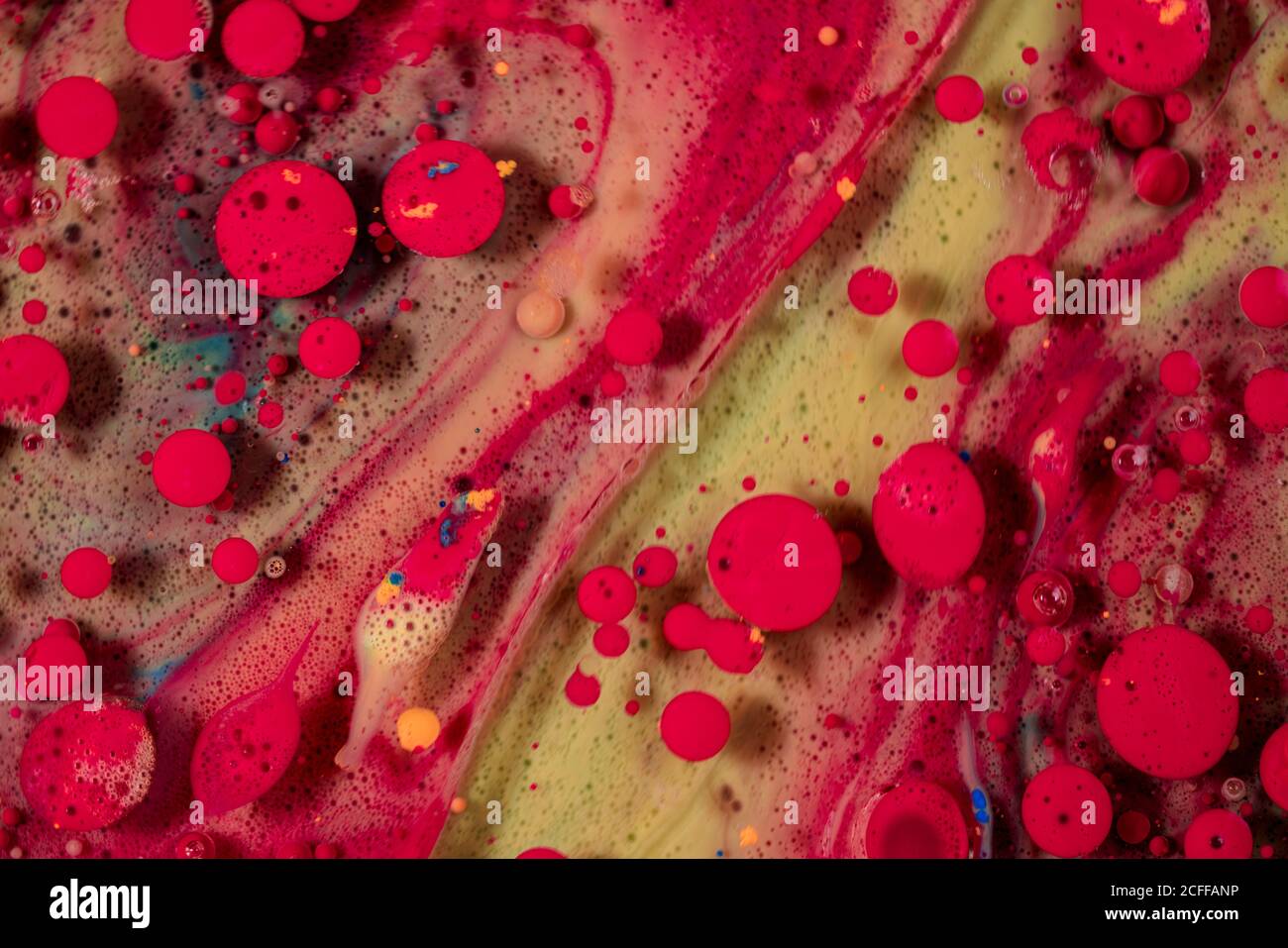 abstract background of multiple bright red bubbles of oil in liquid ...