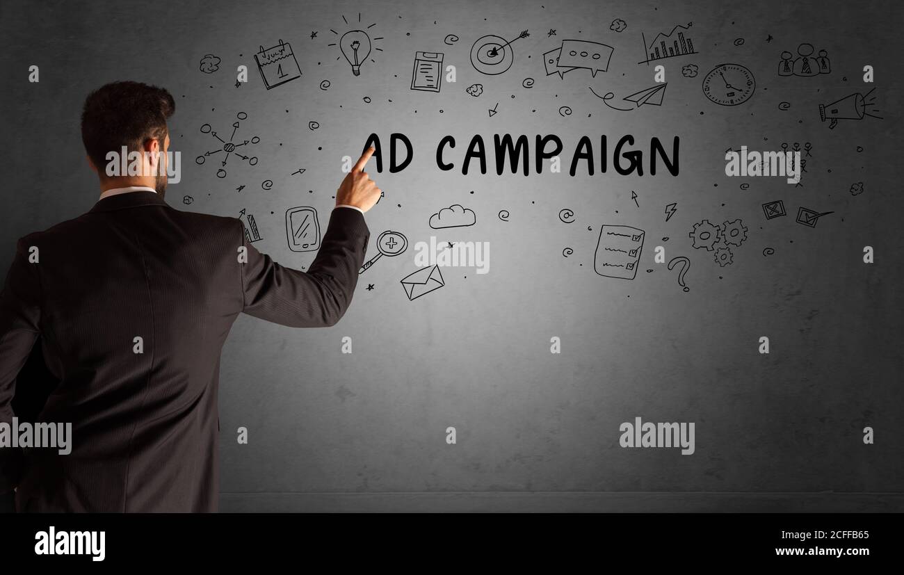 businessman drawing a creative idea sketch with AD CAMPAIGN inscription ...