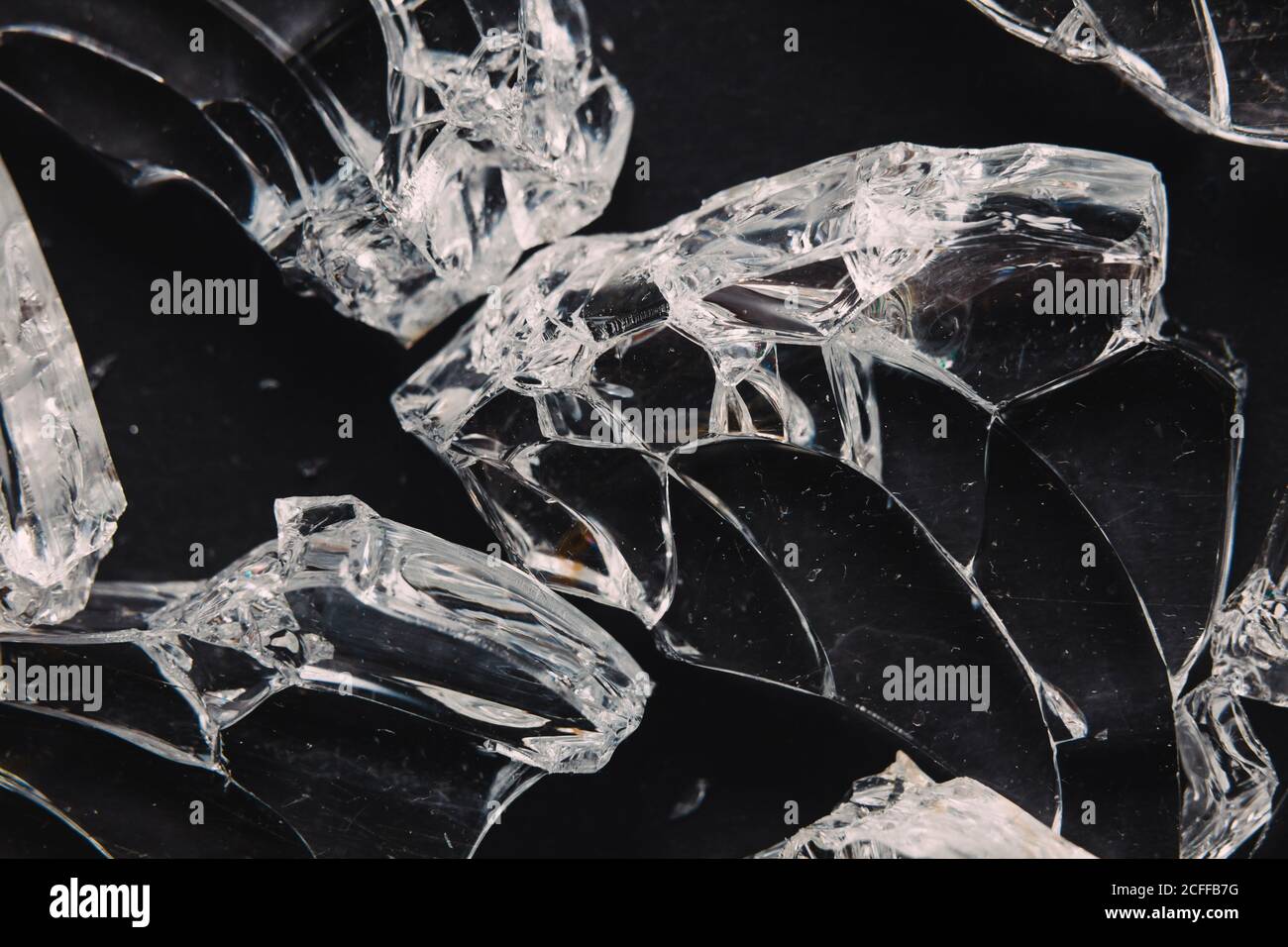 Abstract background with shiny pieces of broken transparent glass on ...