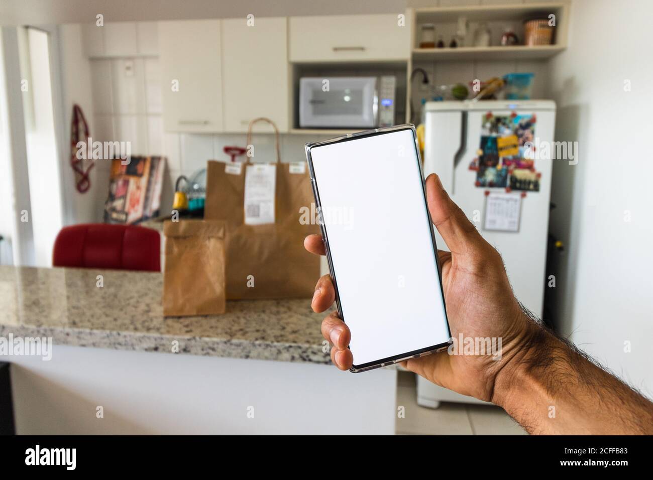 Ordering food online in a mobile, paper bah in background Stock Photo ...