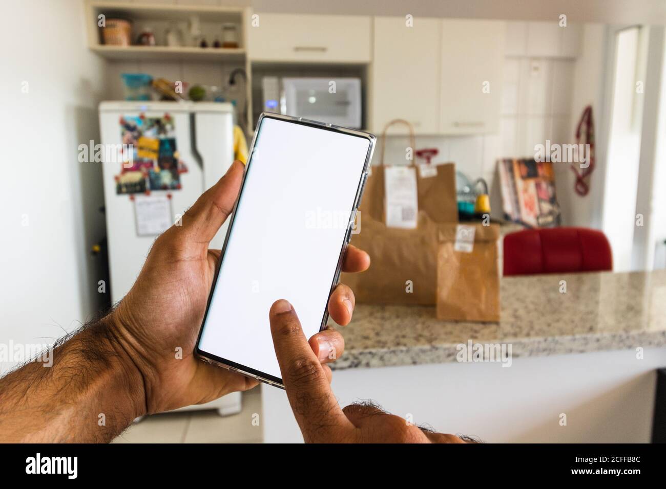 Ordering food online in a mobile, paper bah in background Stock Photo ...