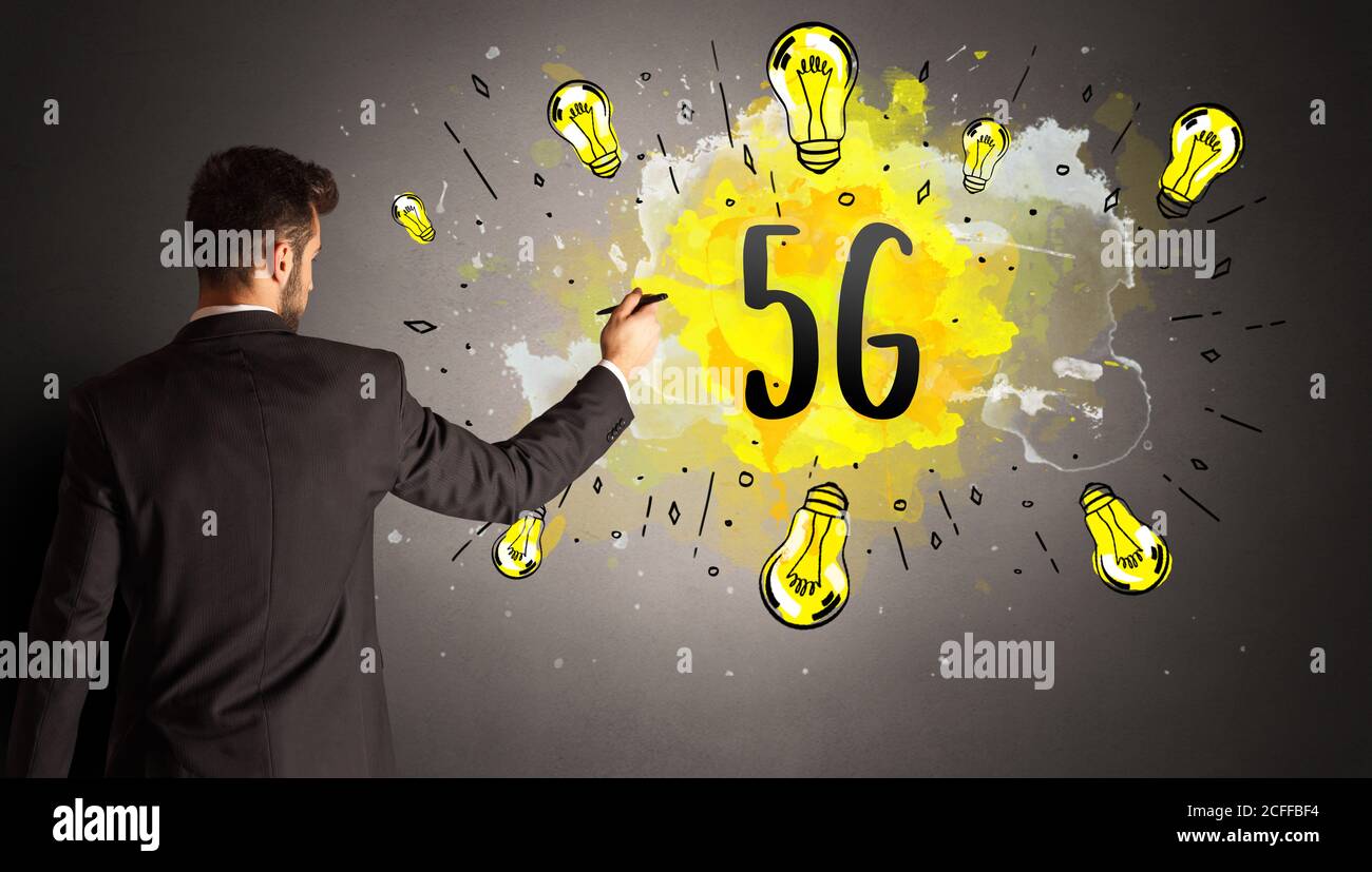 businessman drawing colorful light bulb with 5G abbreviation, new ...