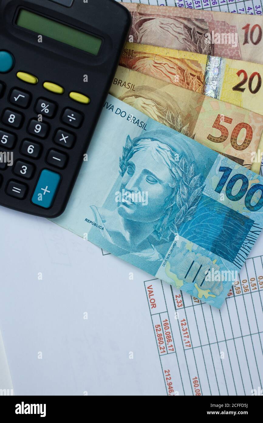 Brazilian money with calculator and numerical chart background Stock ...