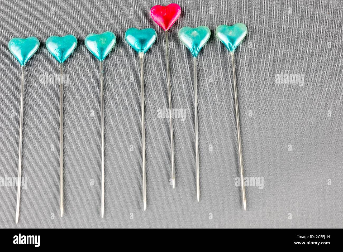 Multi-colored needles in a row Stock Photo - Alamy