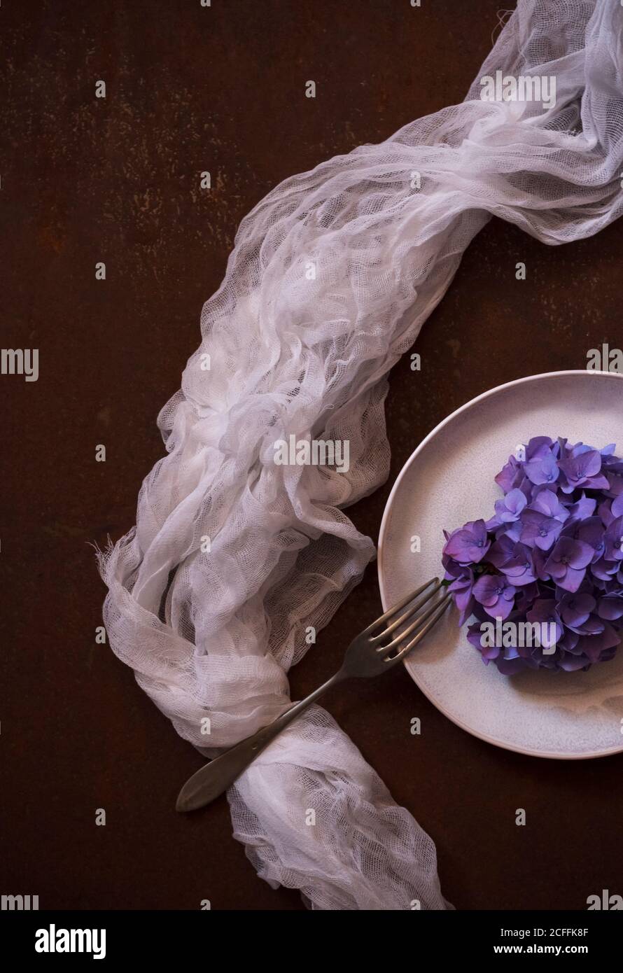 From above thin translucent fabric placed near plate with heap of ...