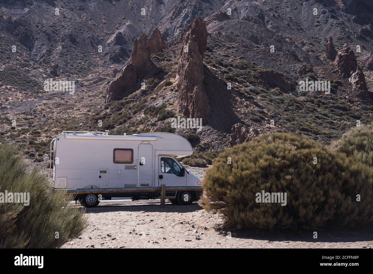 Traveling caravan on roadside in wild desert beside bushes on ...