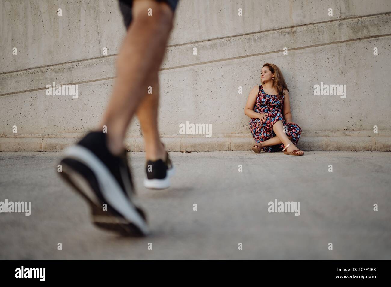 Back view woman sitting on wall hi-res stock photography and images - Alamy