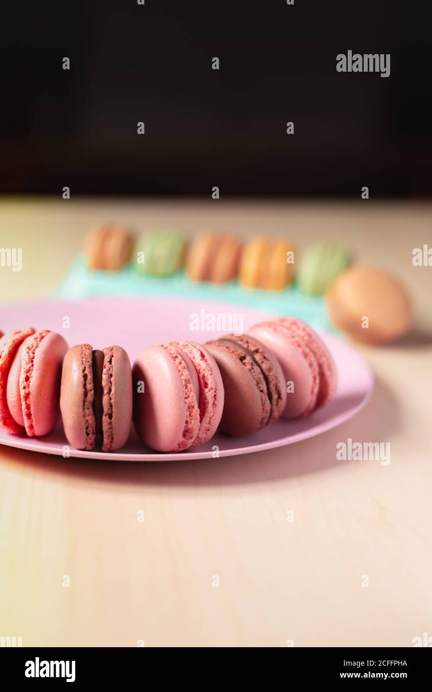 Delicious colorful macaron cookies arranged in shape of emoji smile ...