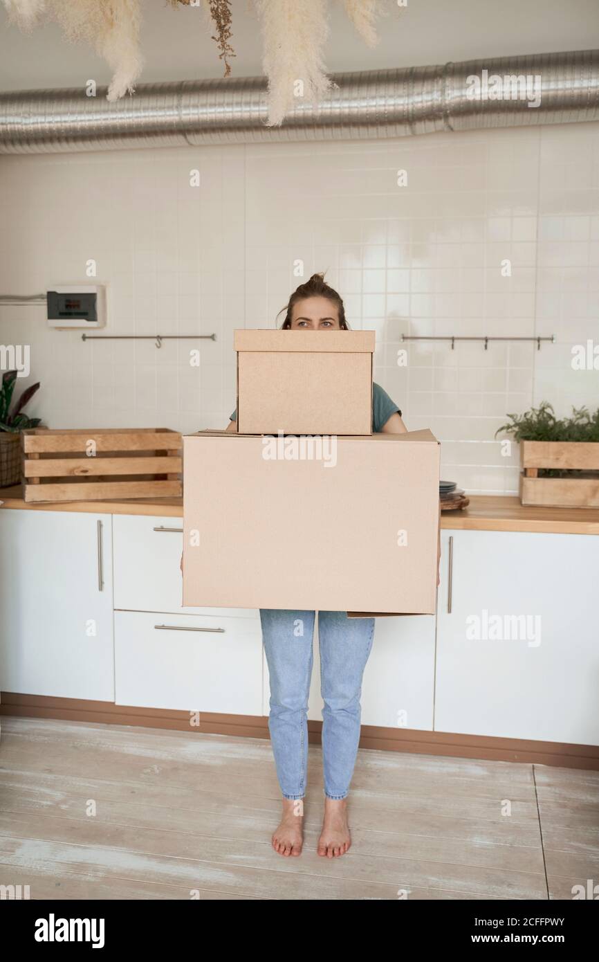 Woman carrying heavy box hi-res stock photography and images - Alamy