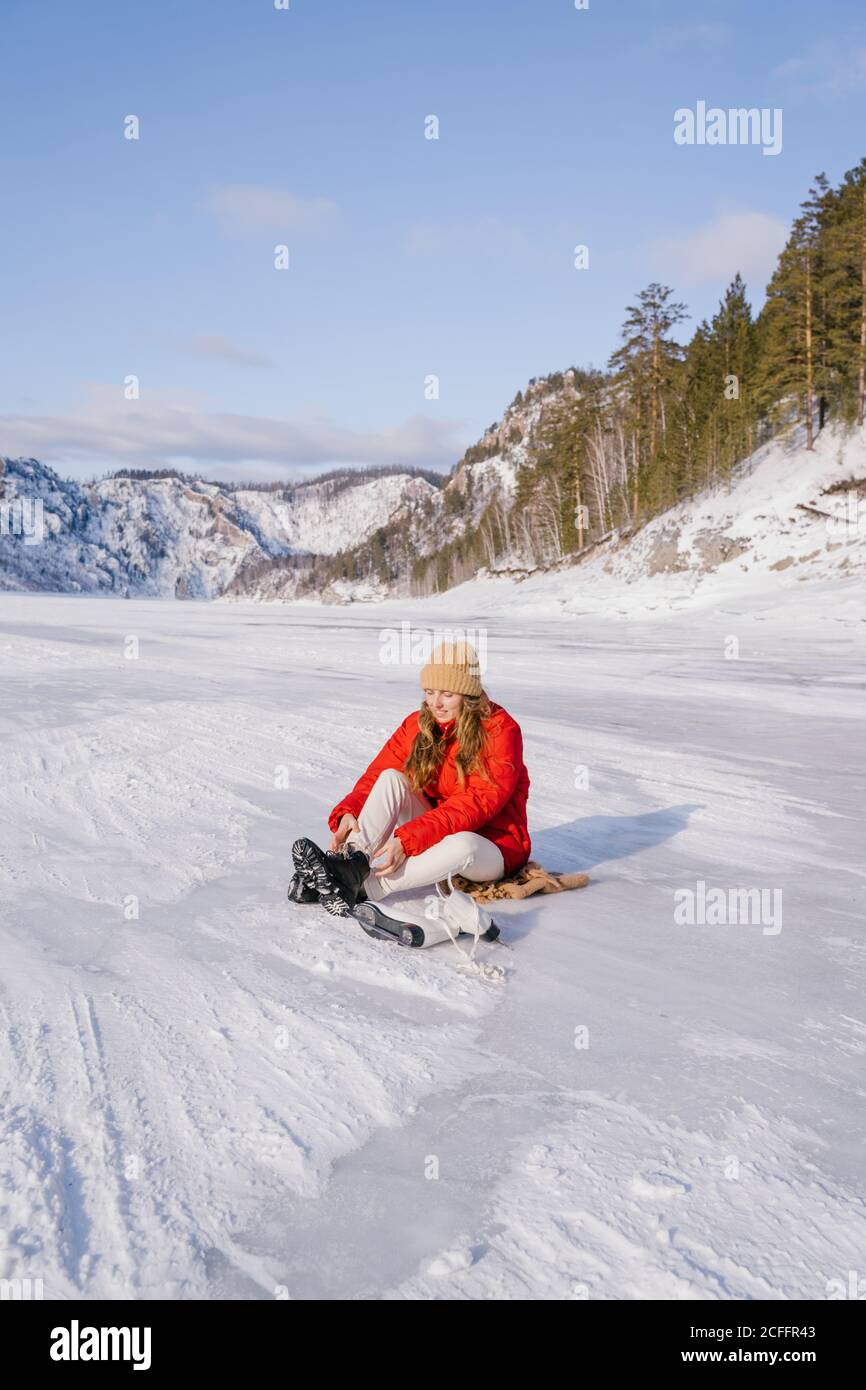 Woman putting on boots hi-res stock photography and images - Alamy