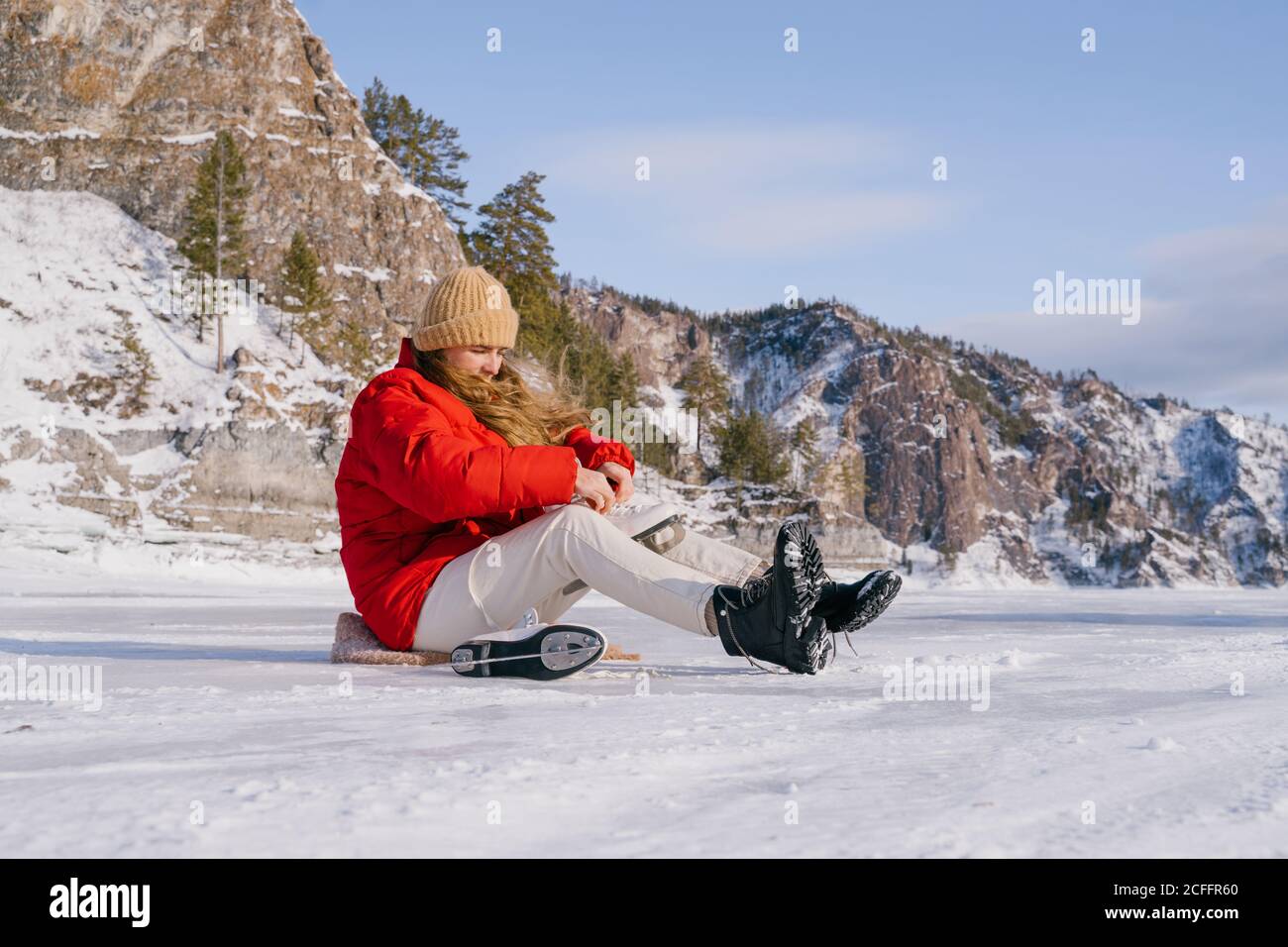 Woman putting on boots hi-res stock photography and images - Alamy