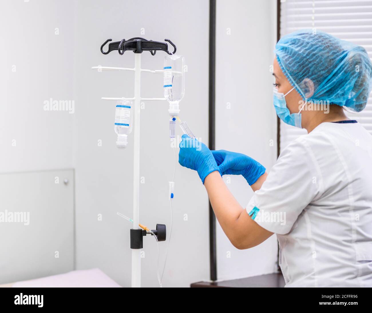 Doctor prepares the system with a dropper and a solution Stock Photo ...