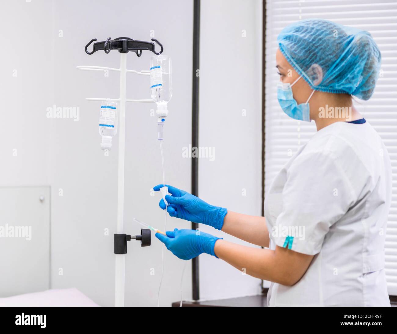 Doctor prepares the system with a dropper and a solution Stock Photo ...