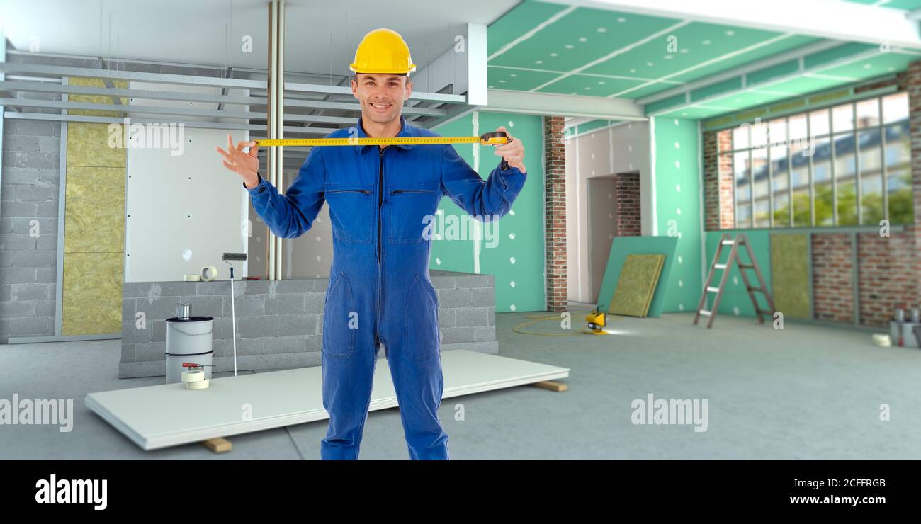 Workman in an interior under construction Stock Photo - Alamy