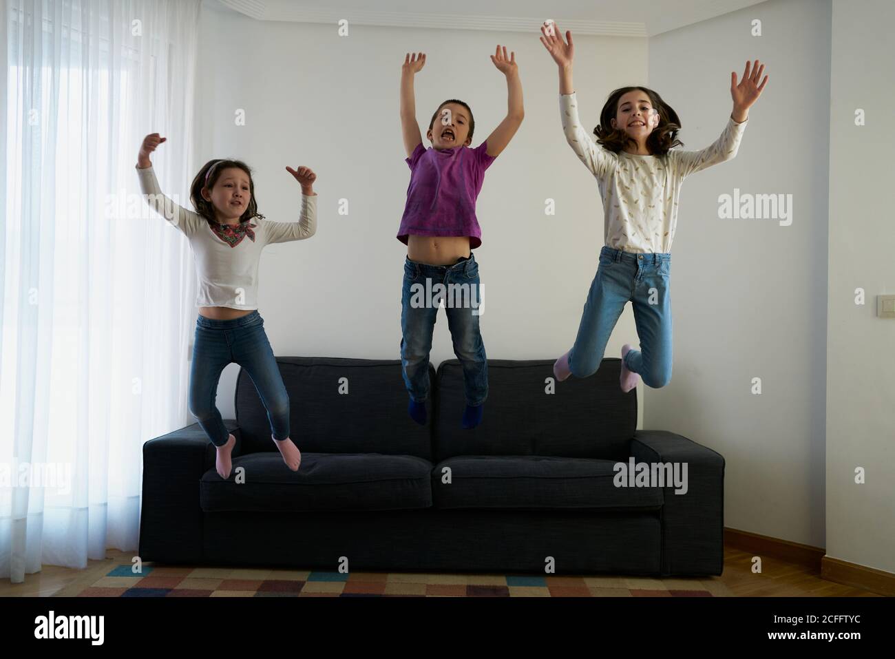 Boy jumping sofa hi-res stock photography and images - Alamy