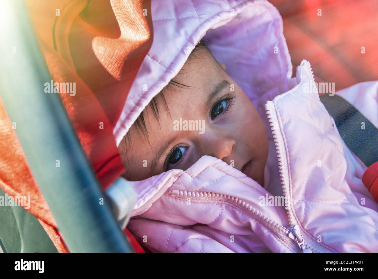 Baby in the cradle ready to sleep. Her body covered in winter clothes ...