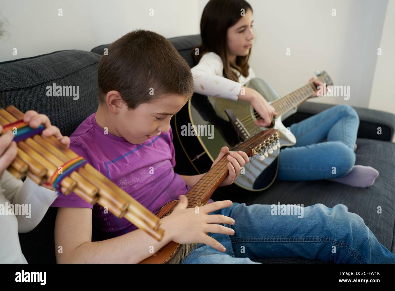 Group of young kids playing music instruments Stock Photo - Alamy