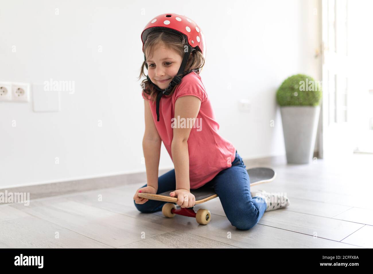 Little kid in red spotted helmet and casual clothes and dreaming about ...