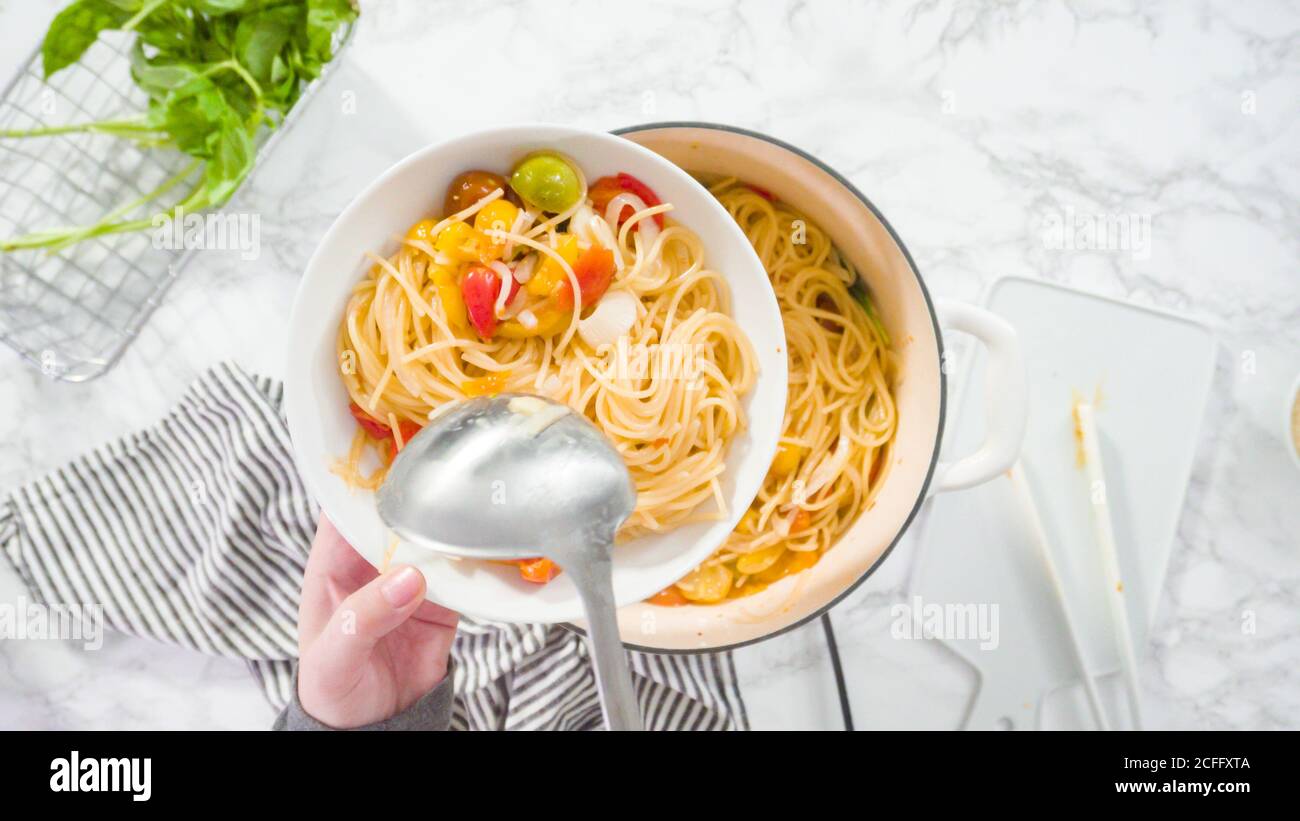 Flat lay. Step by step. Serving a one-pot pasta into a white pasta ...