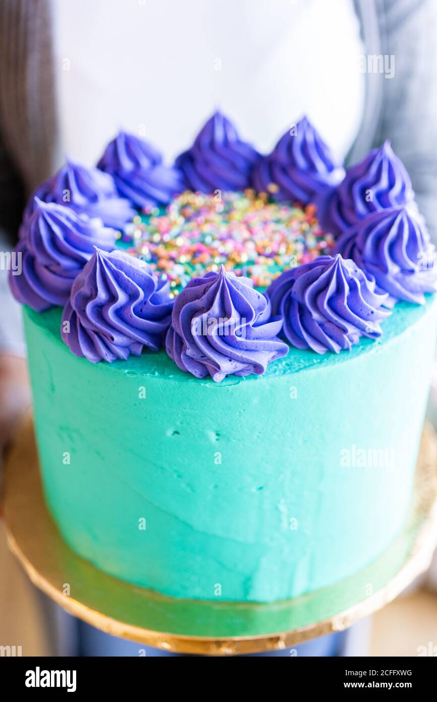 Birthday cake with turquoise buttercream and purple rosettes and ...