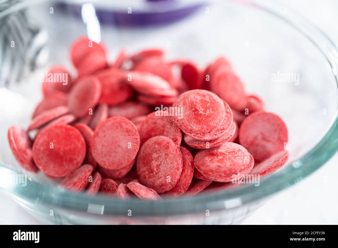 Melting red chocolate melts in the candy melting pot Stock Photo - Alamy