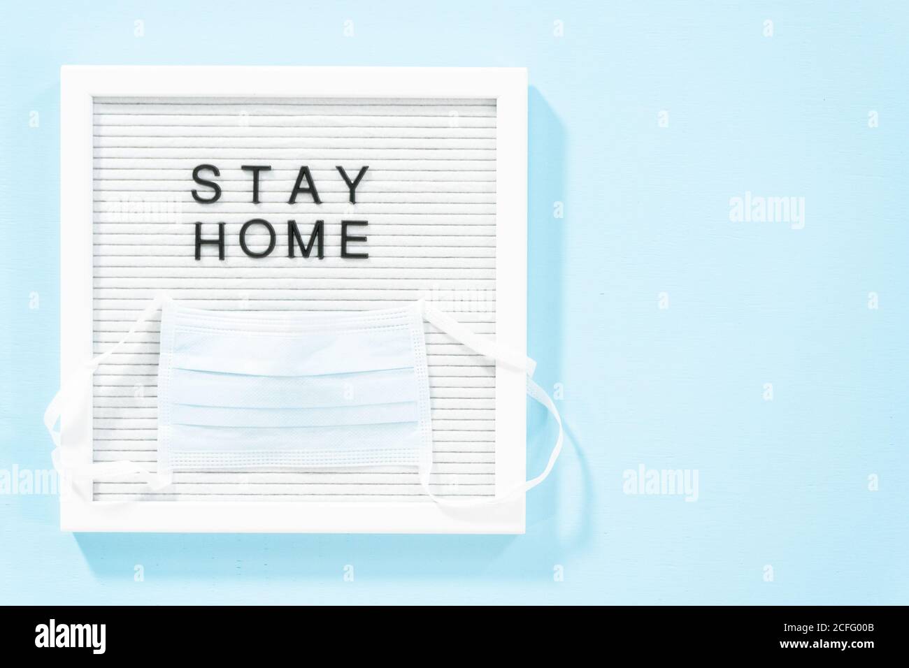 STAY HOME sign on message board with a blue medical mask Stock Photo ...