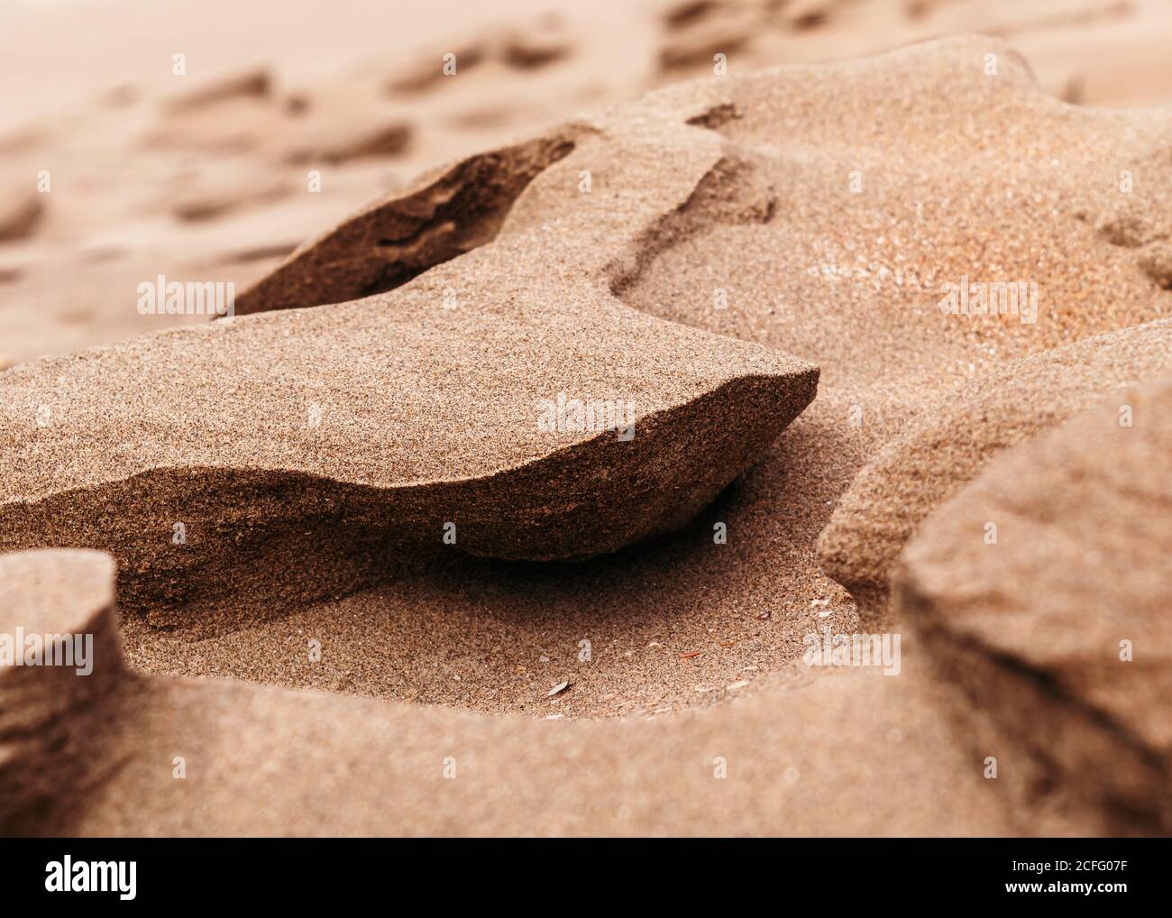 Close-up of sand shaped by water and wind Stock Photo - Alamy