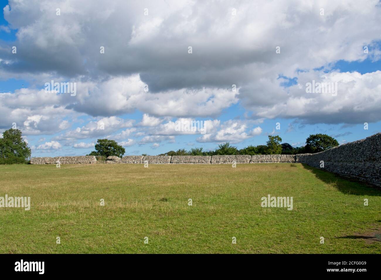 Burgh Castle wall ruins of Roman Fort. Wide view of open ground with ...
