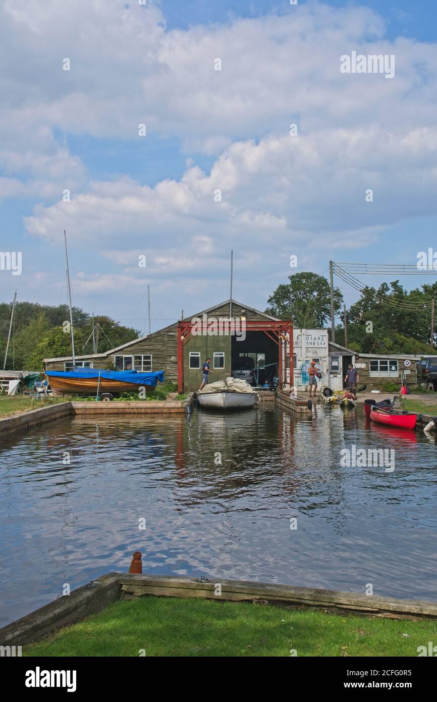 Boatyard on Broads water front. Boats afloat and on hard standing near ...