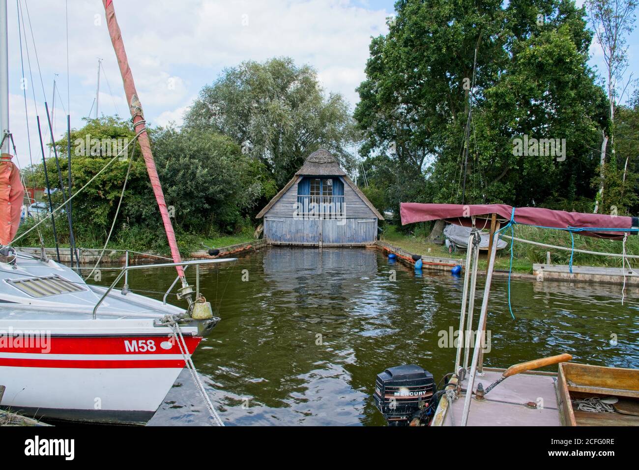 Frontal view of unique thatched roof boat house showing entrance facing ...