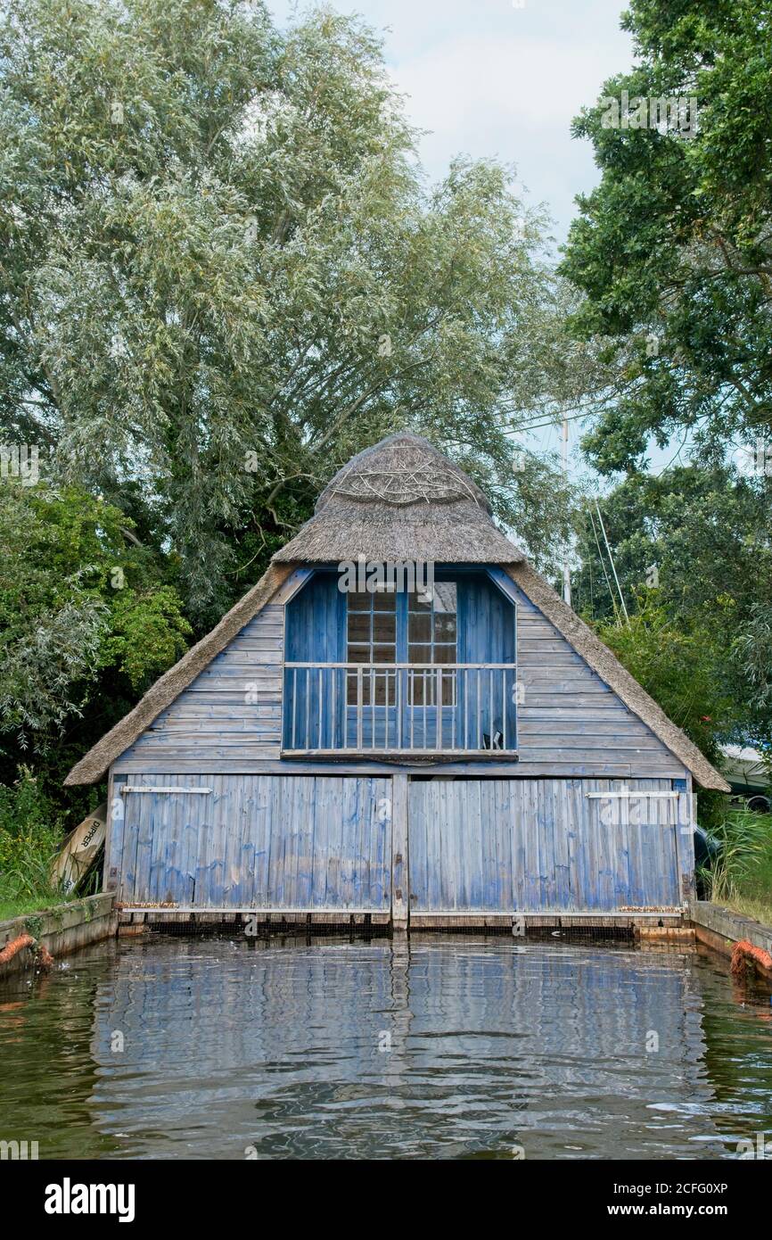 Frontal view of unique thatched roof boat house showing entrance facing ...
