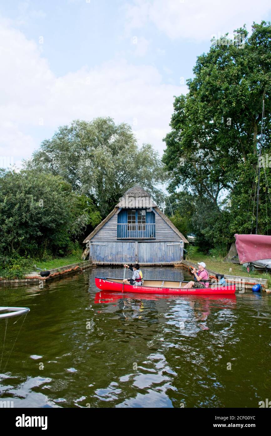 Frontal view of unique thatched roof boat house showing entrance facing ...
