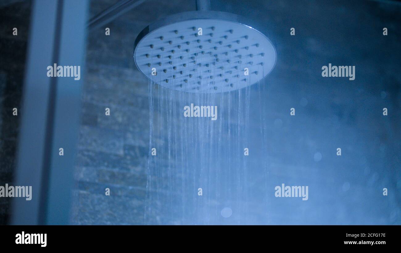 Contemporary design of round chrome shower head with running water in ...