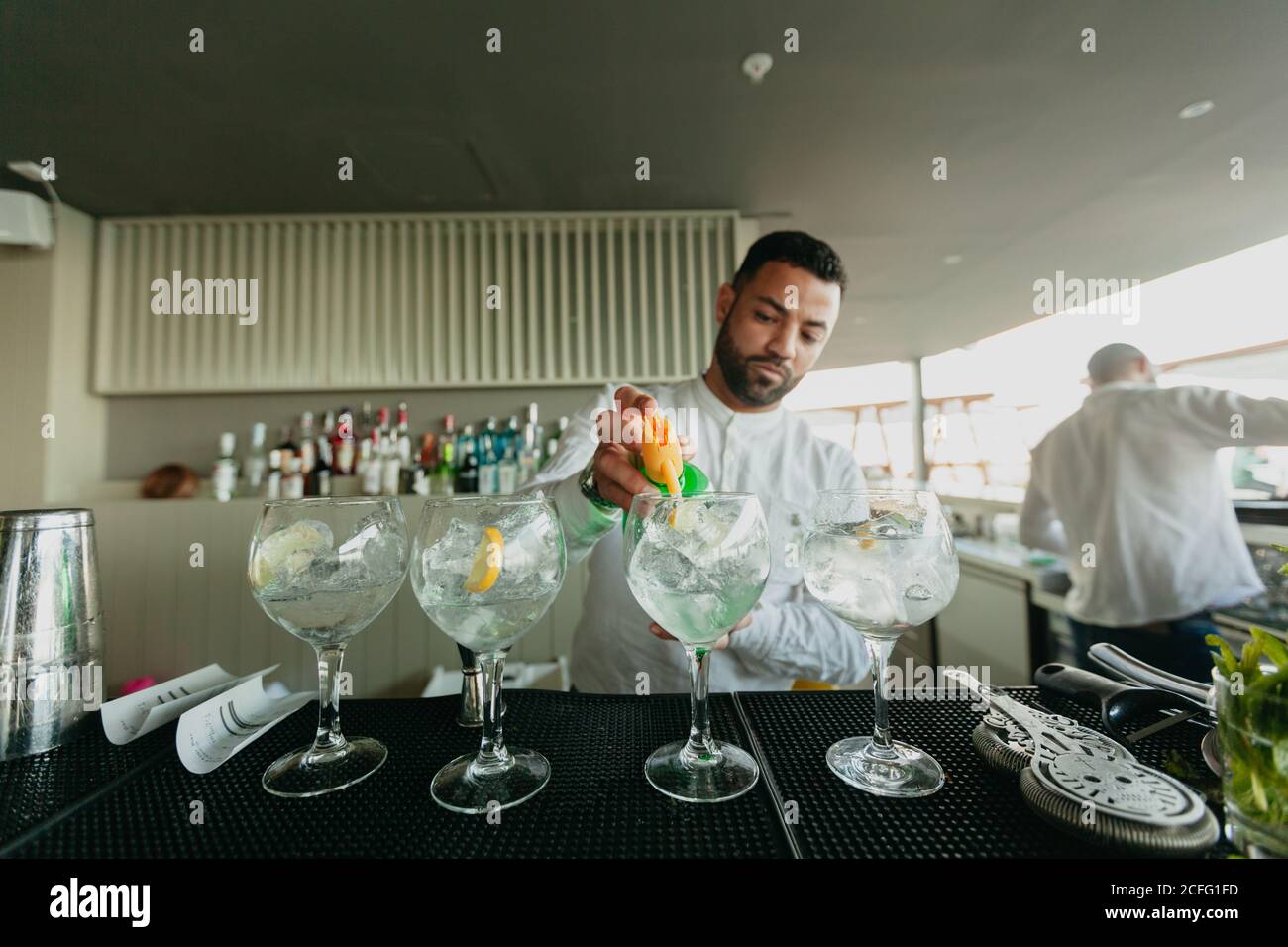 Professional bartender preparing drinks in hi-res stock photography and ...
