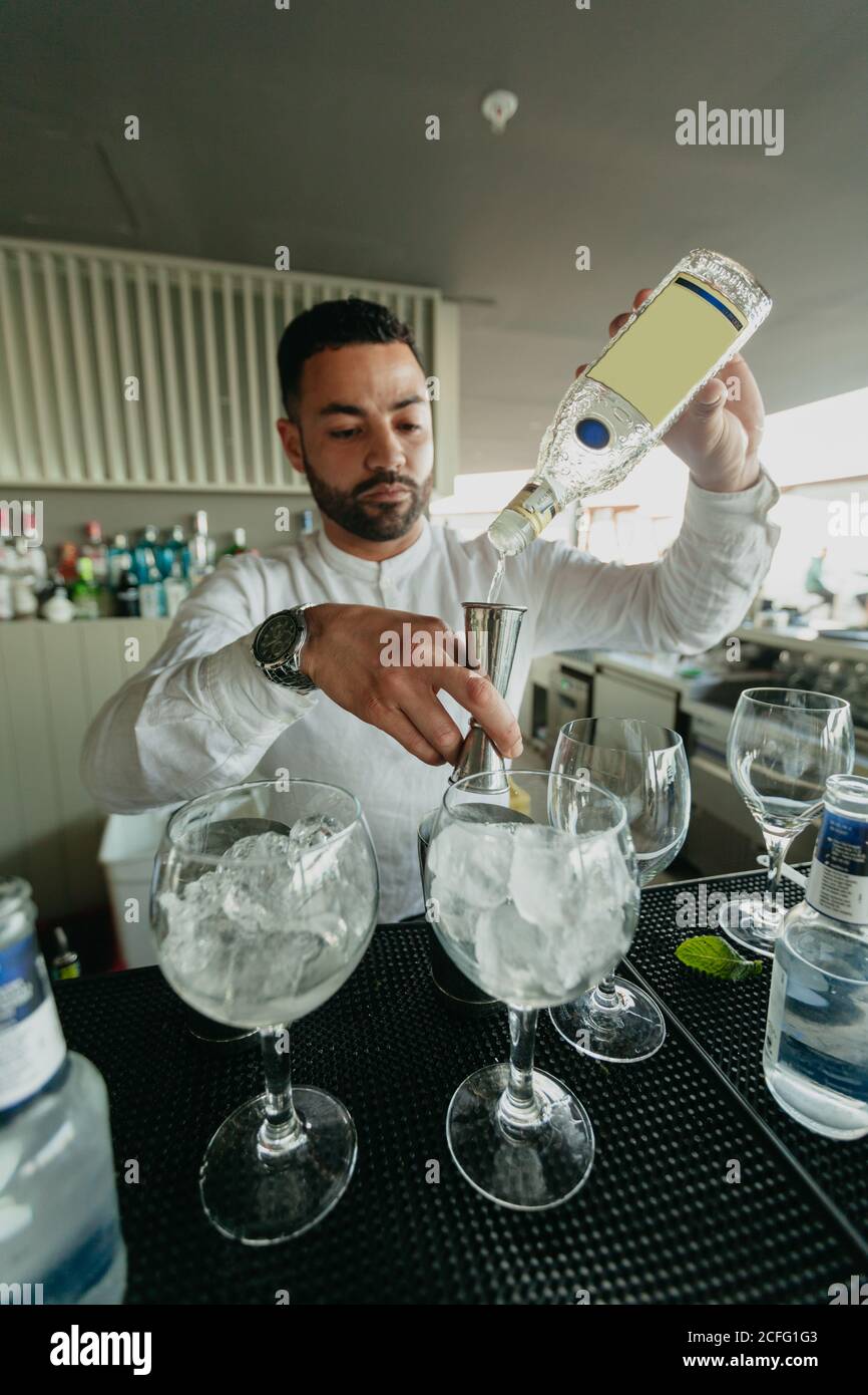 Cheerful man preparing alcoholic drinks in a bar Stock Photo - Alamy
