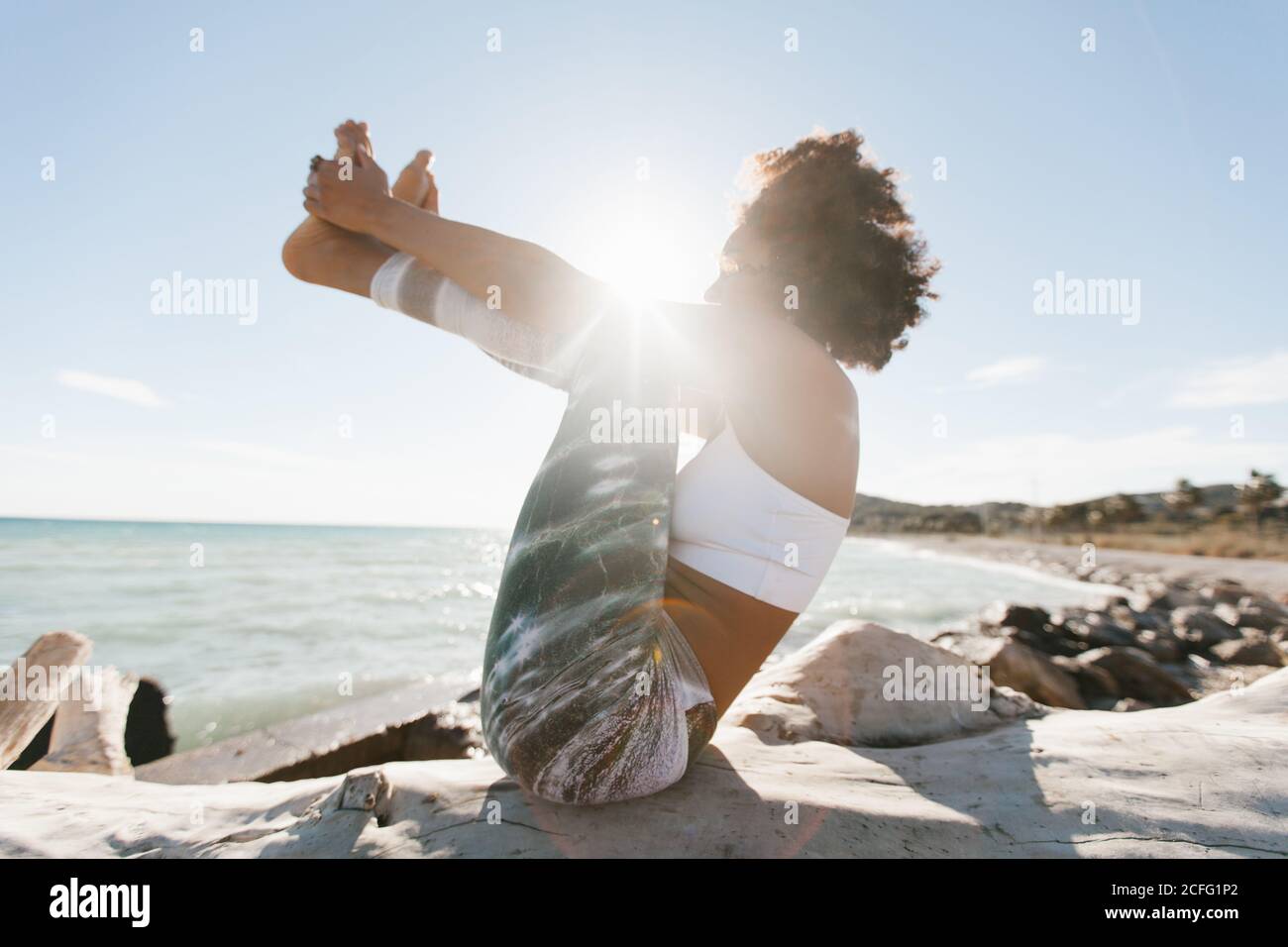 Side view of African American attractive young Woman in yoga posture in ...