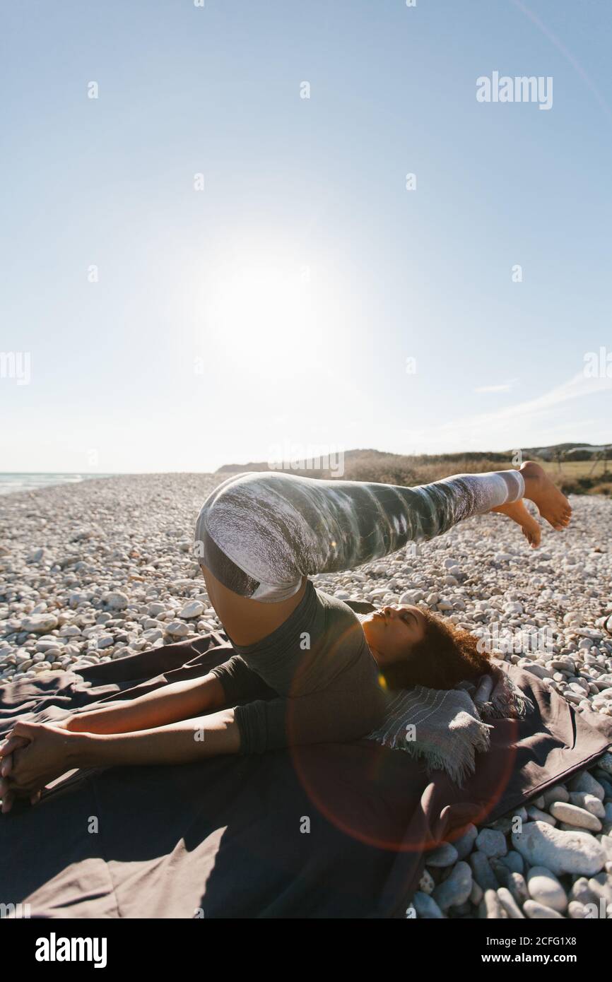African American attractive young Woman in yoga headstand posture in ...