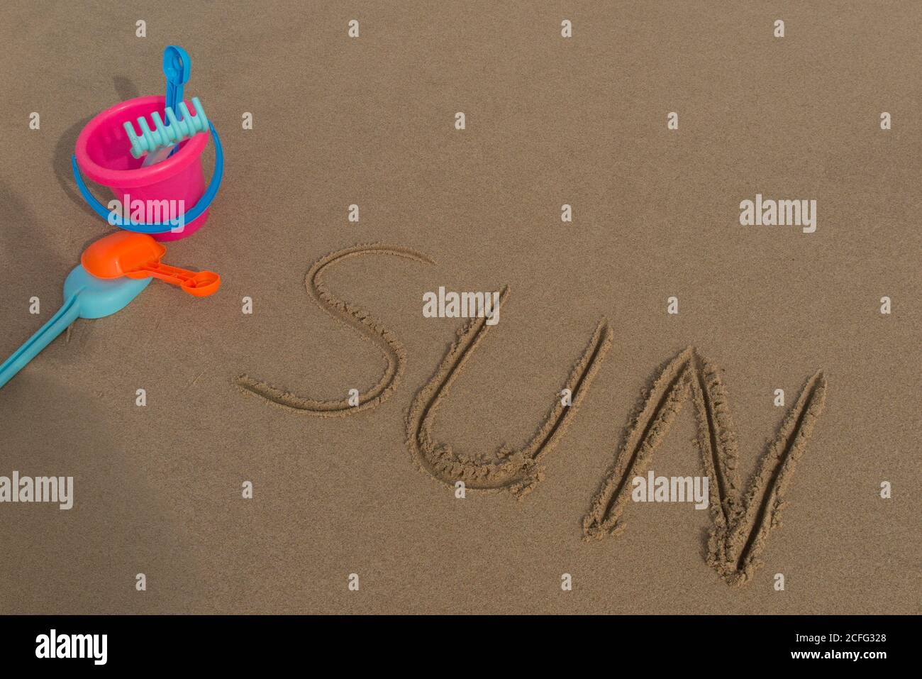 The Word Sun written in the Sand on a Beach with Drawing of the Sun ...