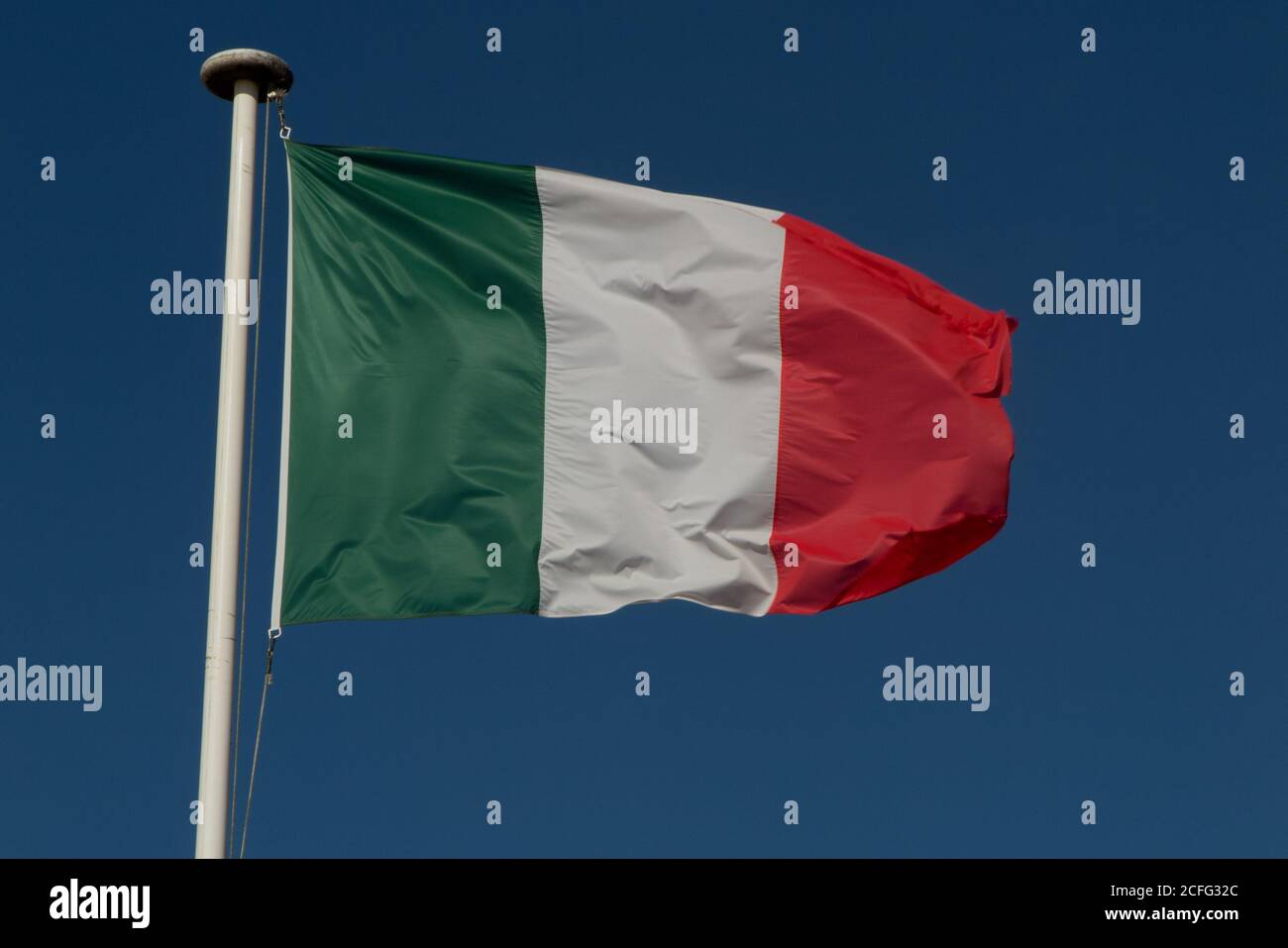 Italian flag fluttering in the wind, with blue sky. Green, White, Red ...