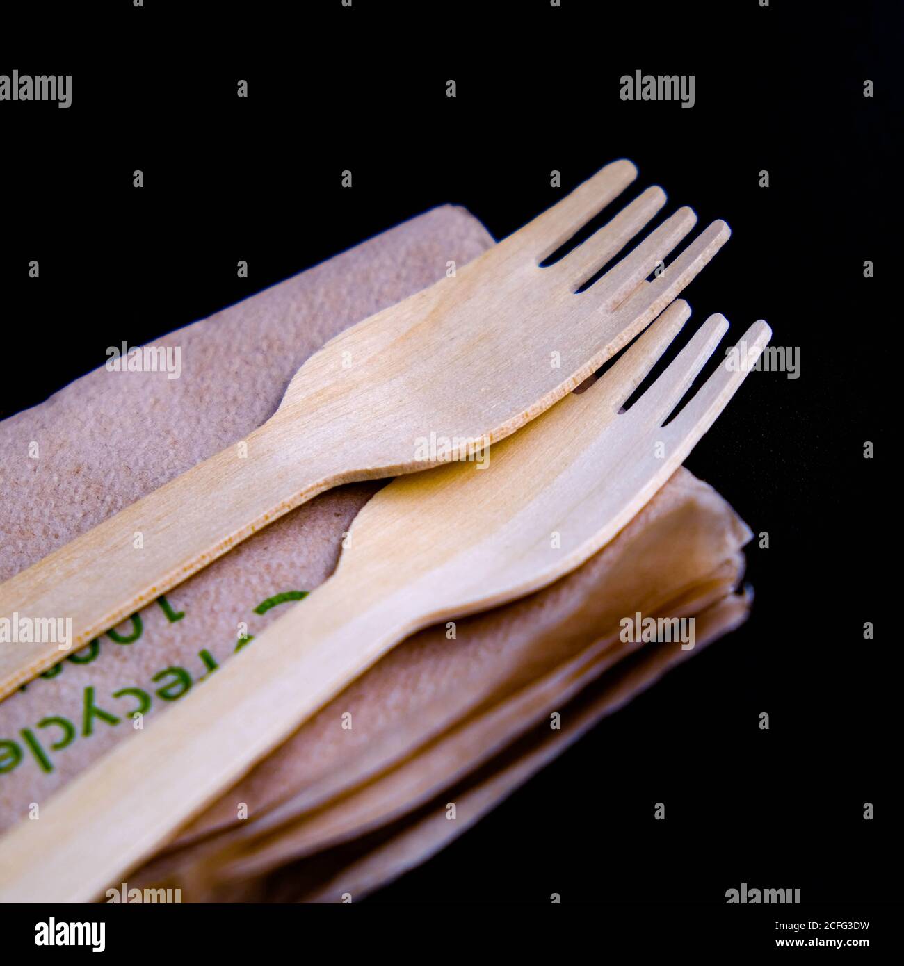 Two Disposable Wooden Recyclable Forks Against A Black Background With ...