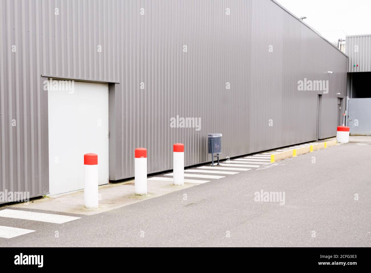modern new grey warehouse hangar exterior with emergency exit door gate ...