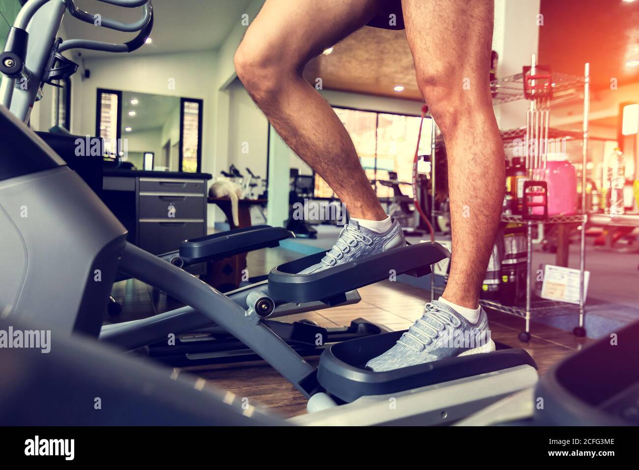 Fitness equipment using elliptical exercise machine hi-res stock ...