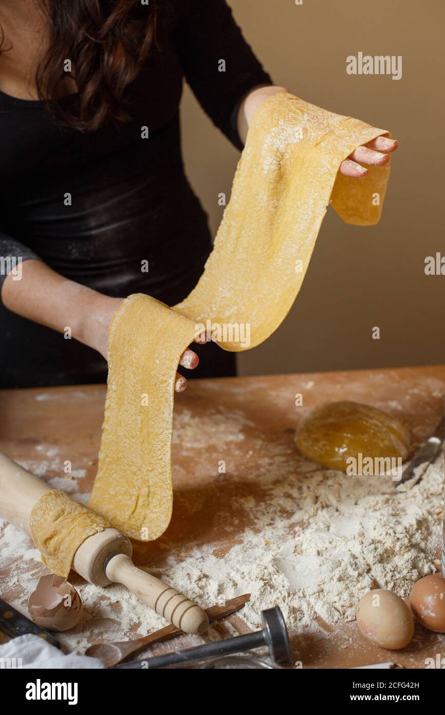 Back view of anonymous male traveler with backpack and trekking sticks ...