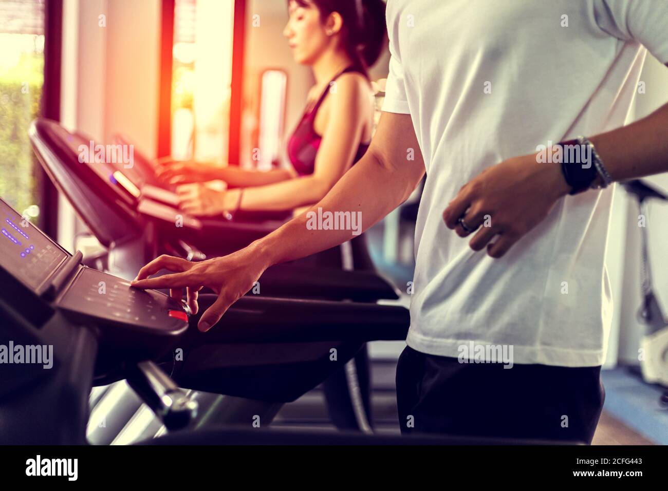 finger pressing on button of running machine in gym Stock Photo - Alamy