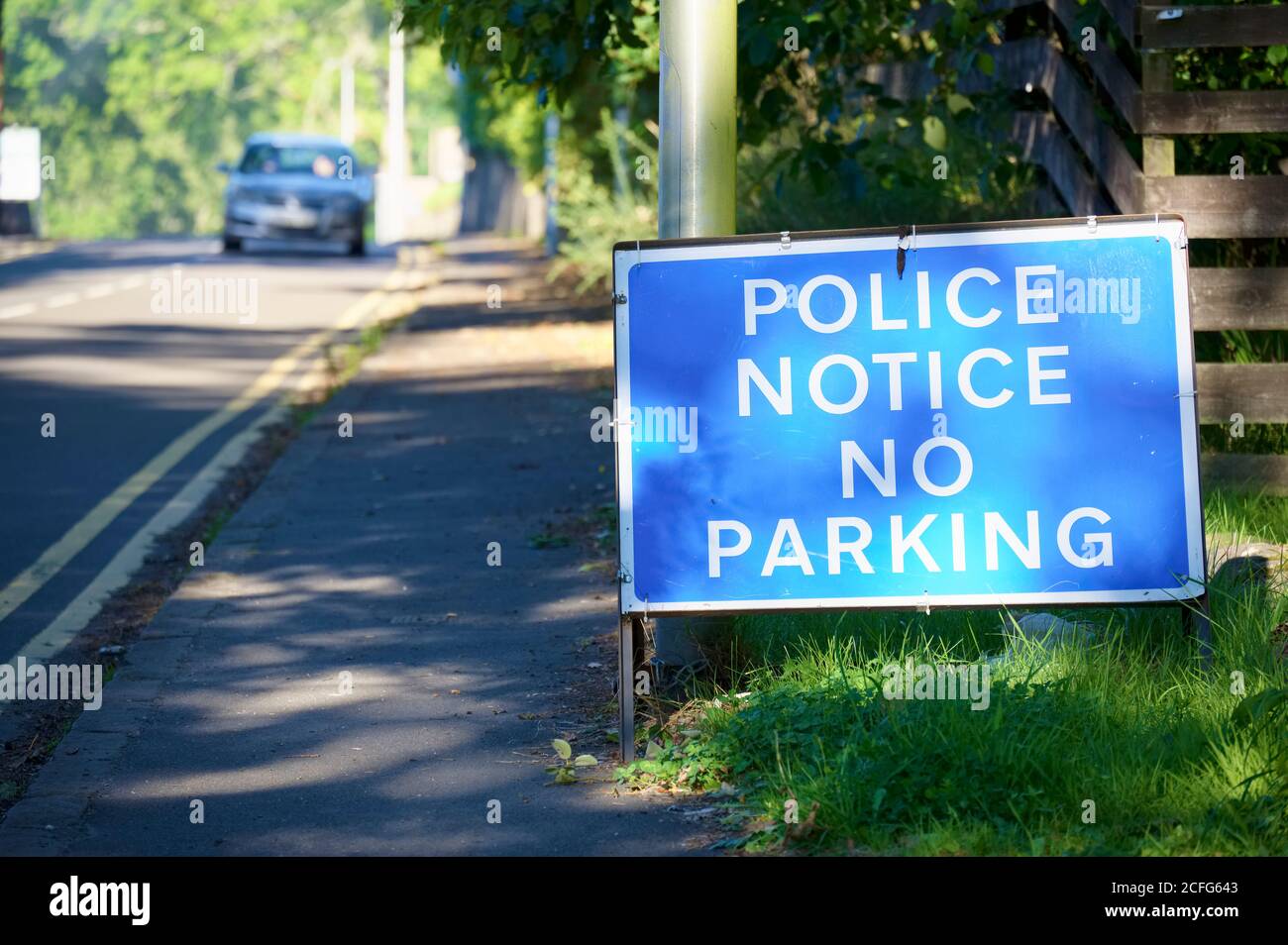 Police notice no parking blue road sign Stock Photo - Alamy