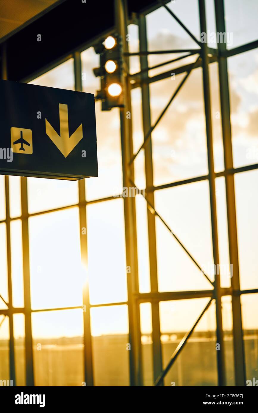 Black sign with yellow arrow pointing direction and airplane location ...