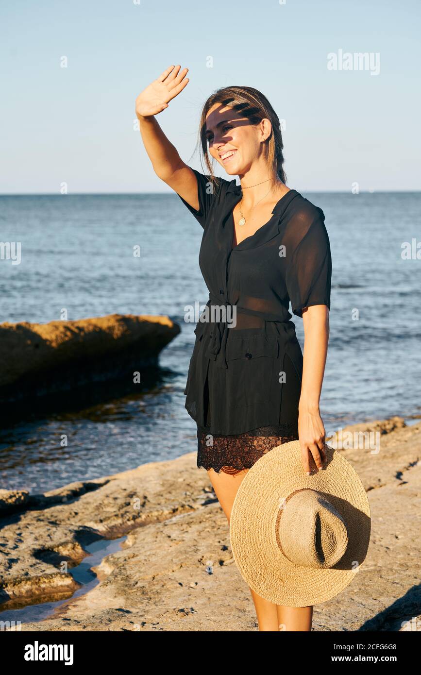Young beautiful female model enjoying sun covering face from sun on ...